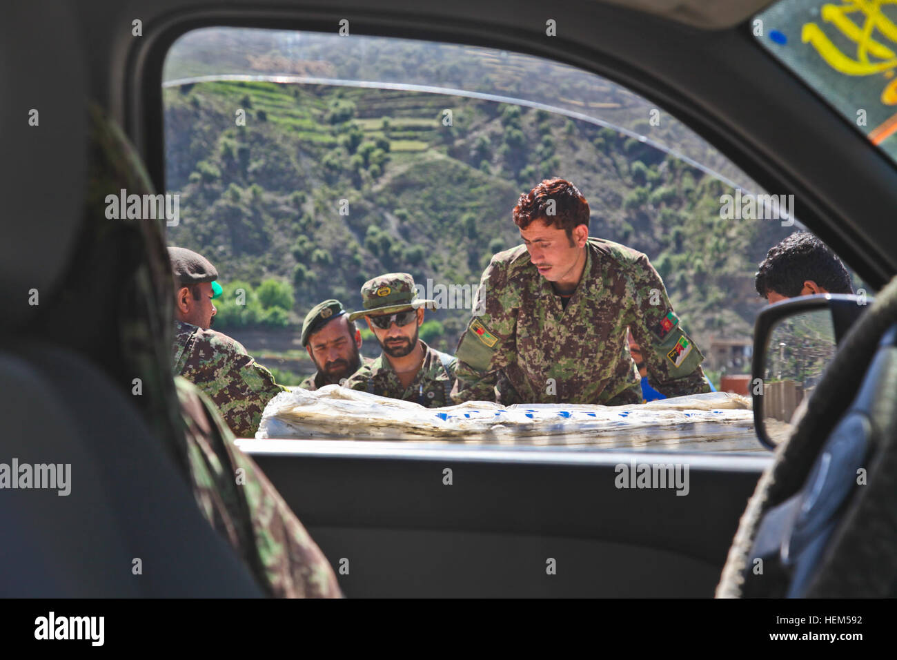 An Afghan National Army (ANA) solider, center, checks the placement of ...