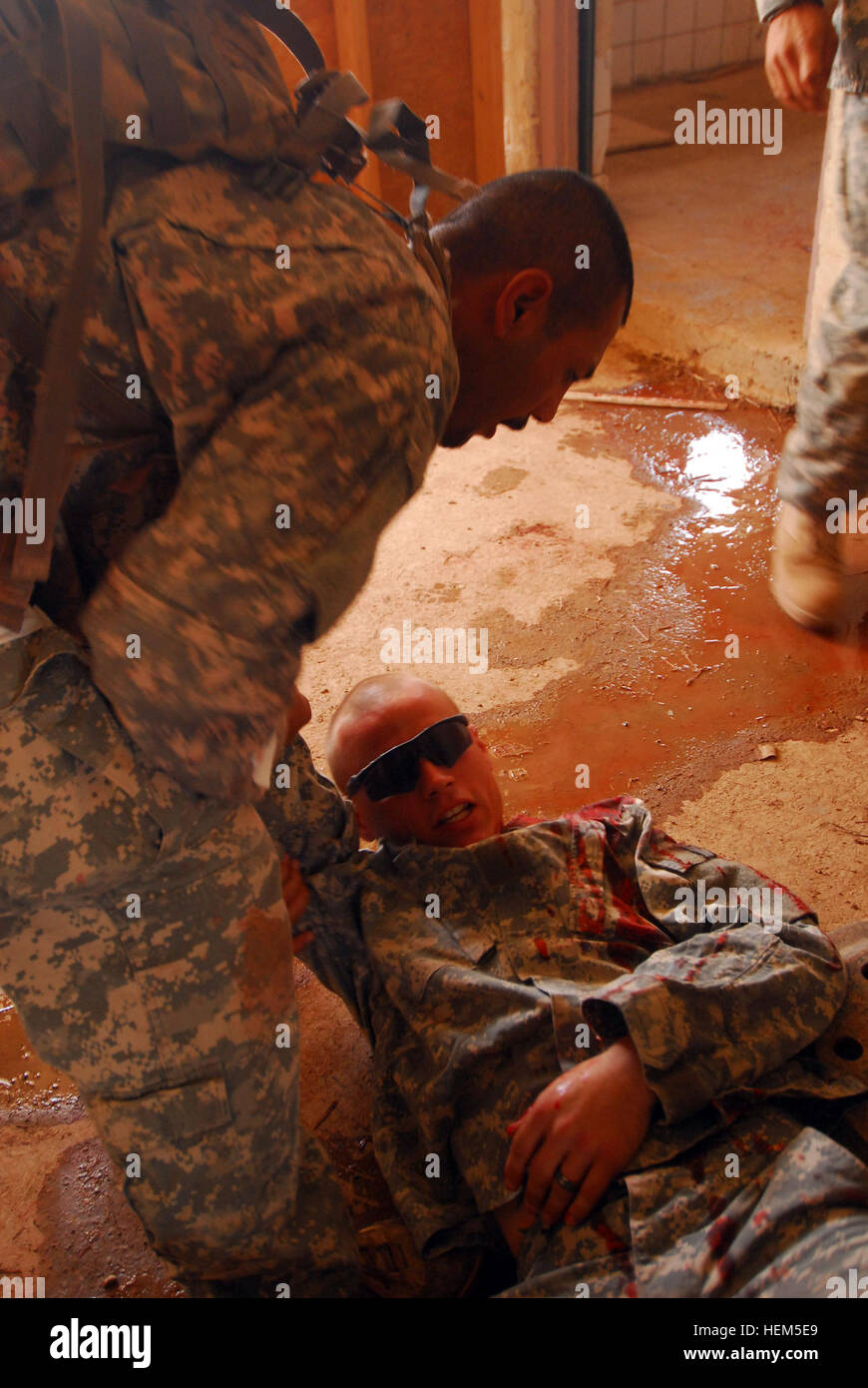 During a trauma lane training event, an Iraqi medic evaluates the ...
