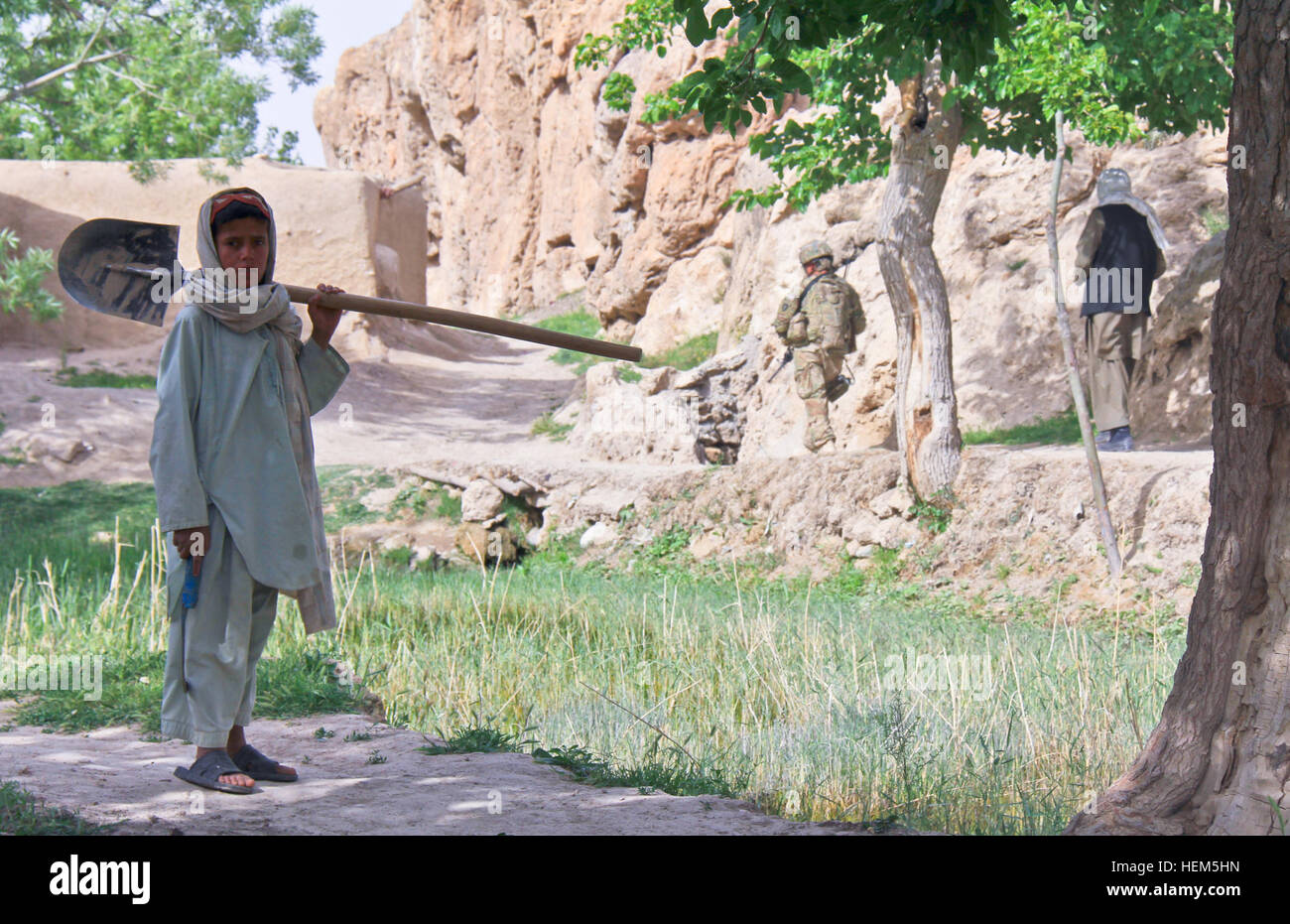 An Afghan boy watches the Zabul PRT pass by; U.S. Army Sgt. Alan Dock ...