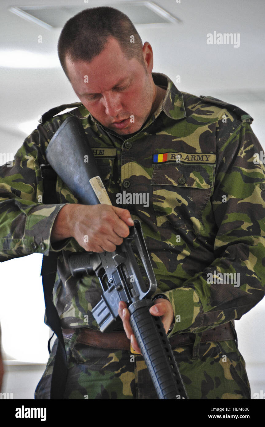 Romanian army Sgt. 1st Class Daniel Enache completes reassembling an ...