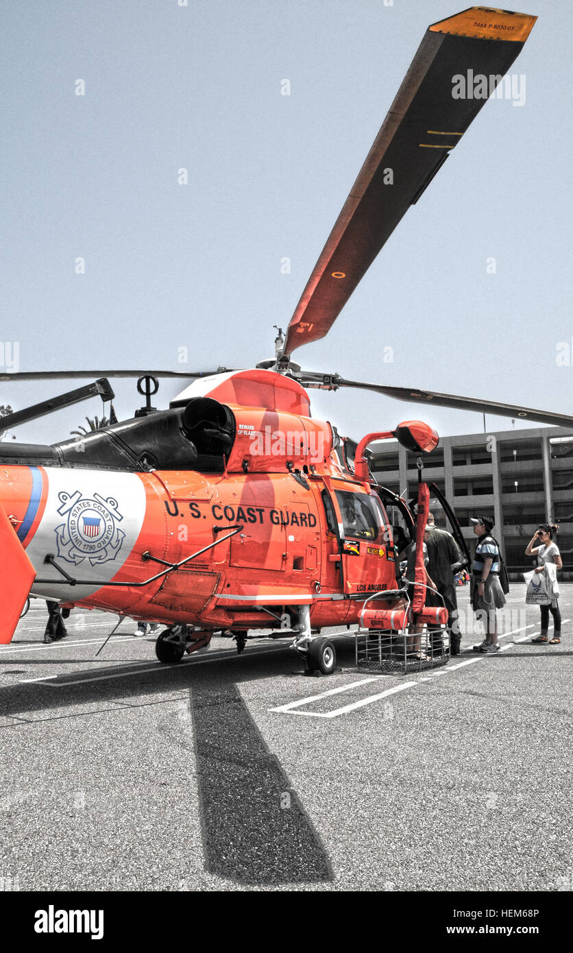 Members of the public line up to look inside a Coast Guard MH-65C ...