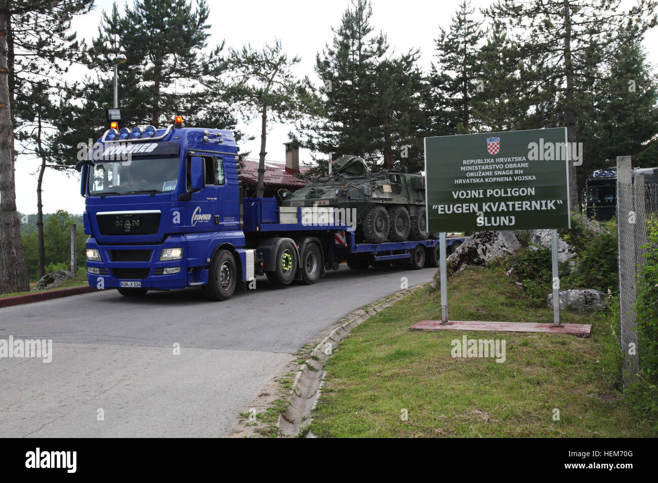 A convoy of flatbed trucks transporting U.S. Army Stryker Armored ...