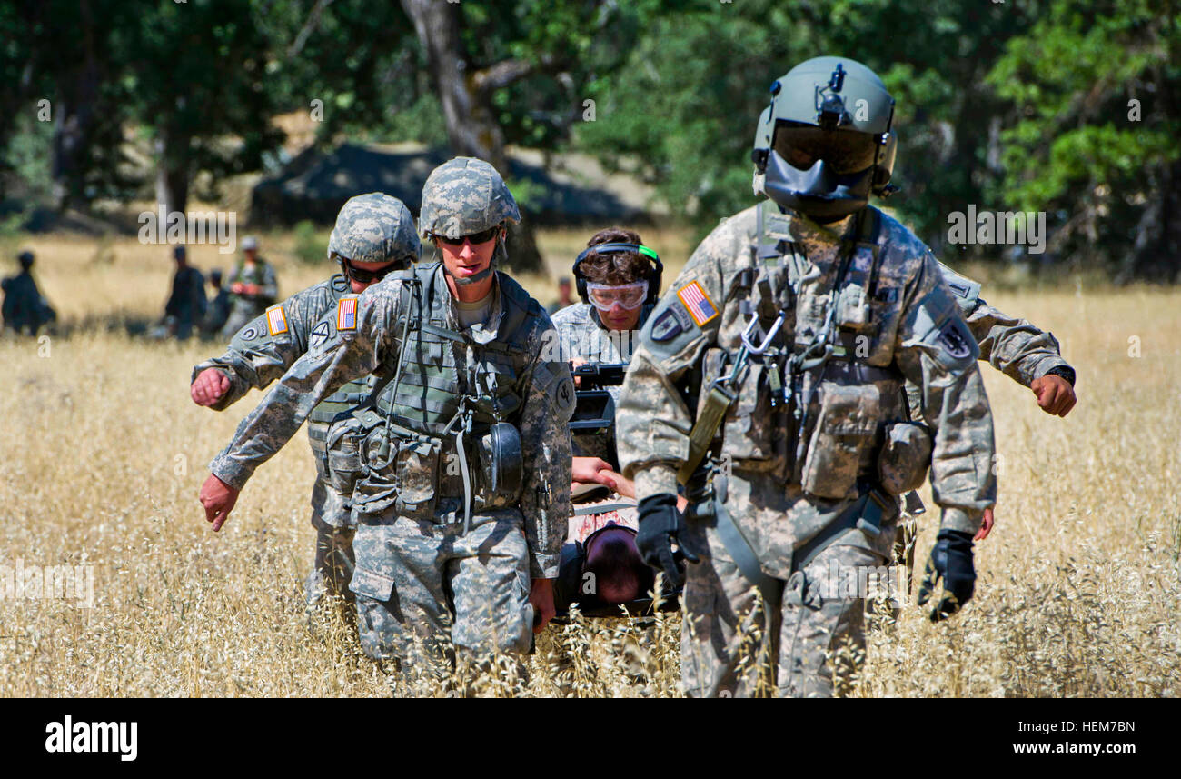 U.S. Army medical personnel carry a simulated patient to a UH-60 Black ...