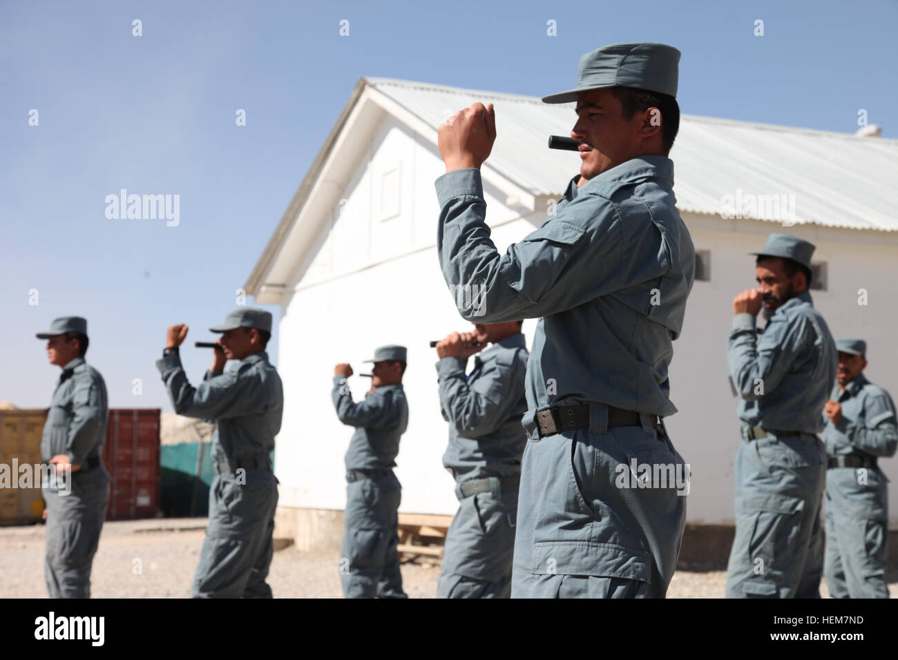 A group of Afghan Uniform Police recruits stand in the ready position ...