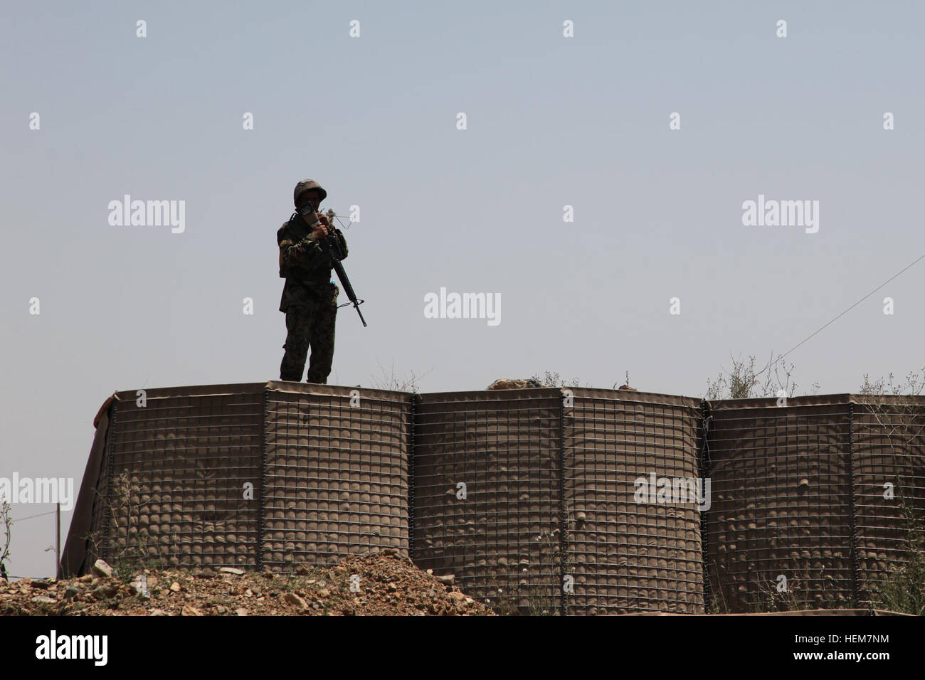 An Afghan National Army soldier provides security from the walls on ...