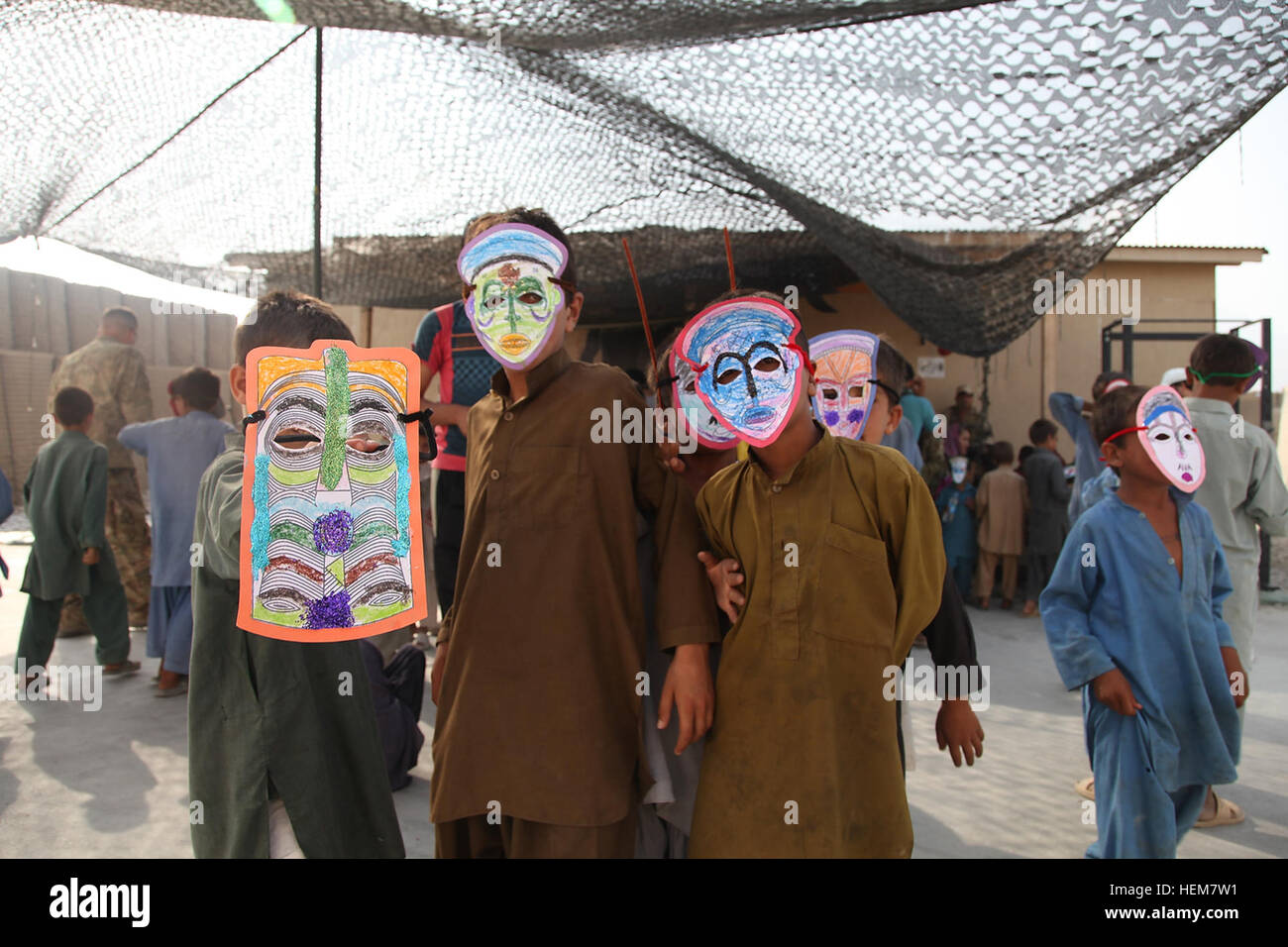 A group of Afghan boys show their mask during a cultural event ...