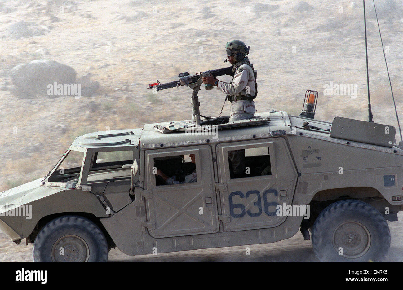 Sergeant David Price runs the machine gun in a High-Mobility ...