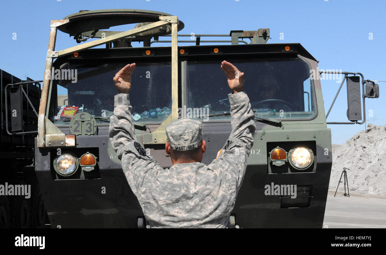 A U.S. Army National Guard truck driver guides a Palletized Loading ...