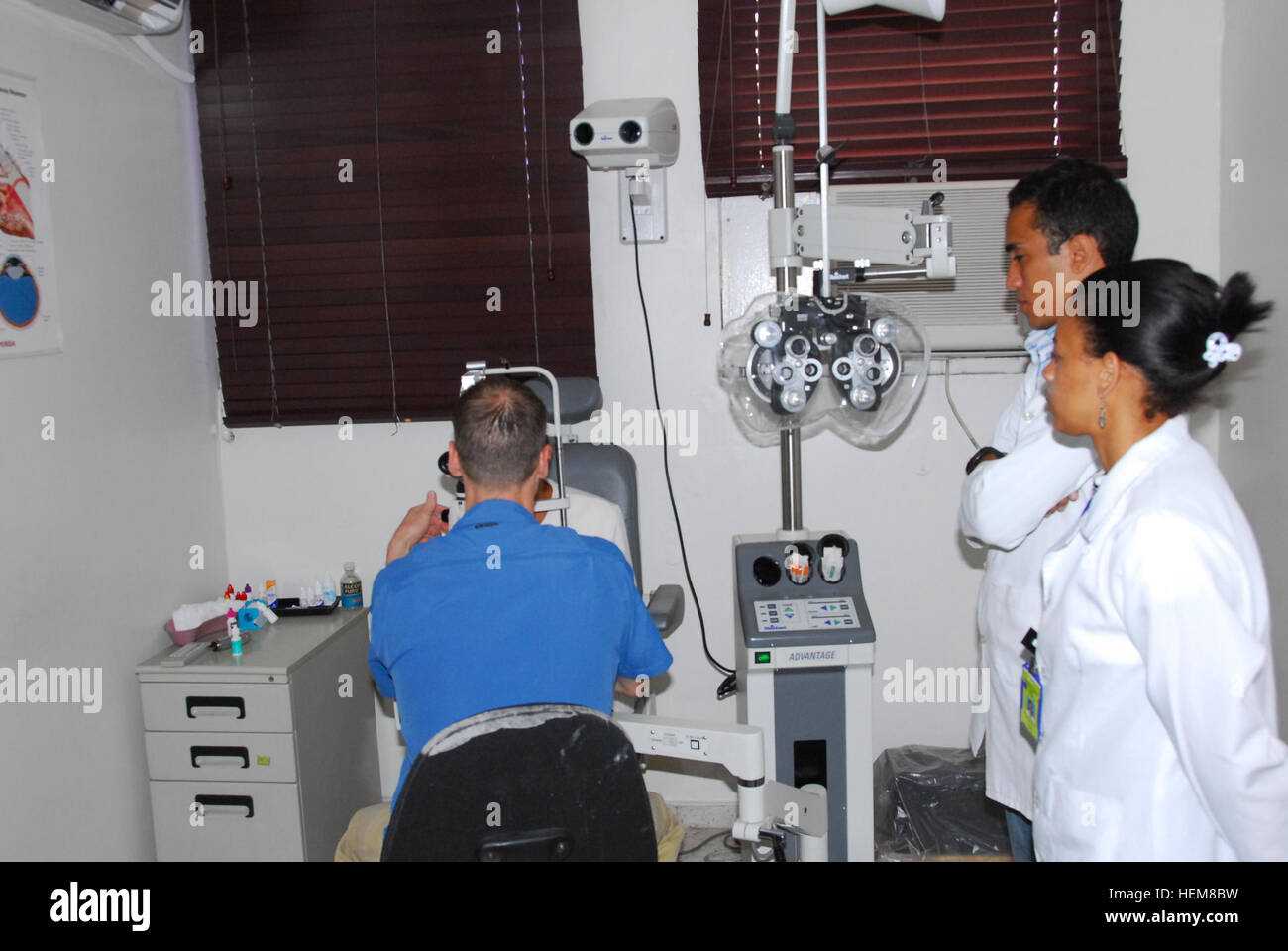 U.S. Army Maj. Brett Nelson (left), an ophthalmologist from Fort Carson ...