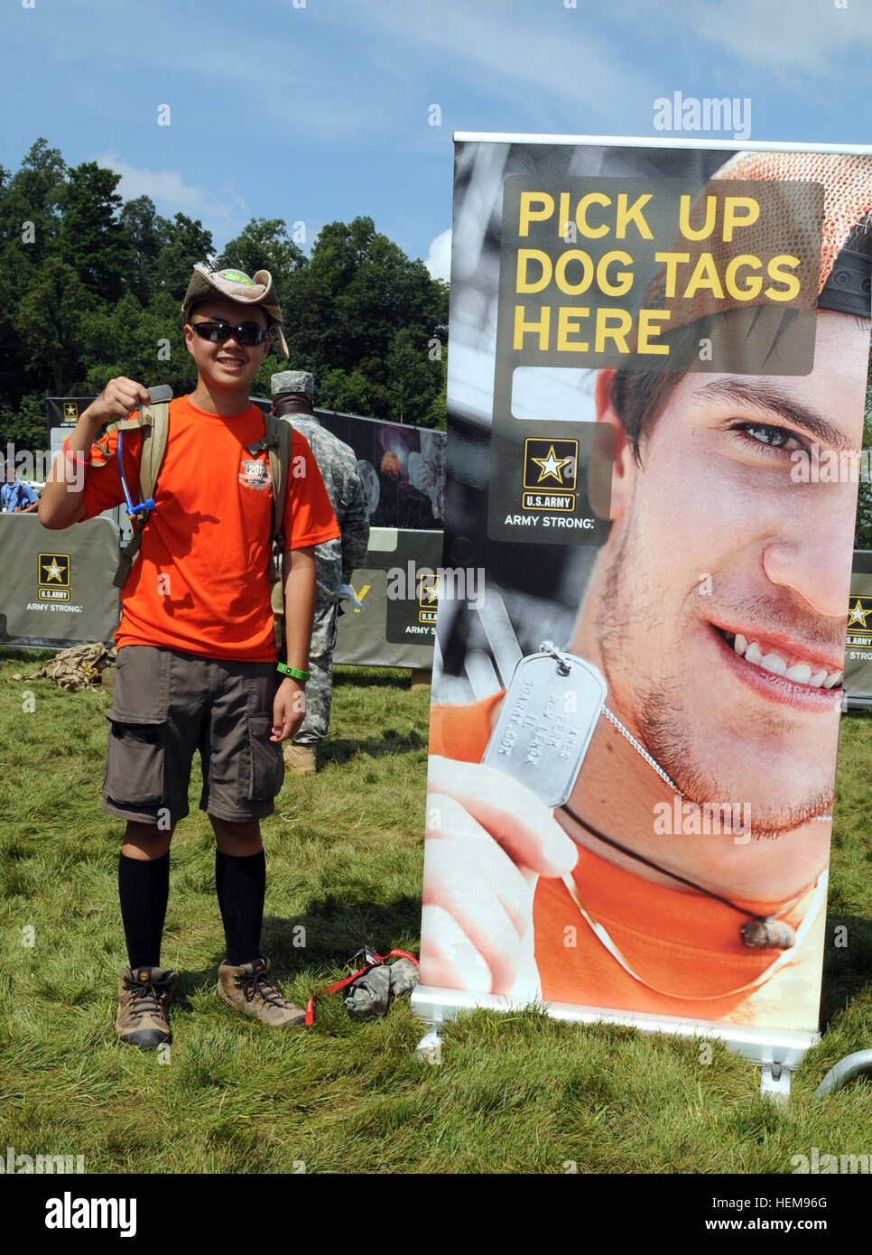 A boy scout stands proudly with his new dog tags after completing ...
