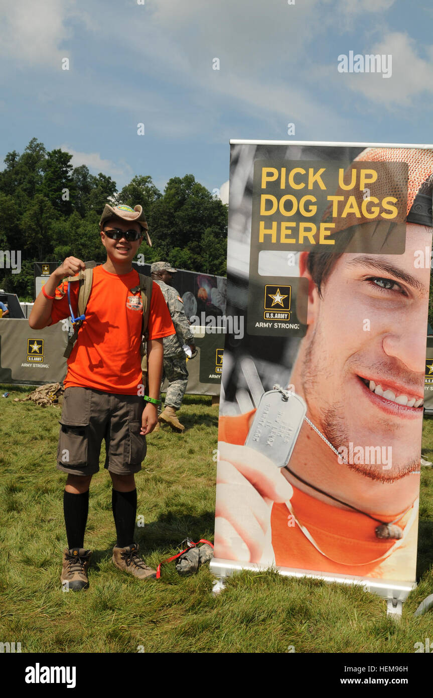 A boy scout stands proudly with his new dog tags after completing ...