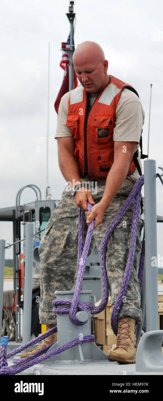 A 7th Sustainment Brigade soldier secures the ties to his mike boat ...