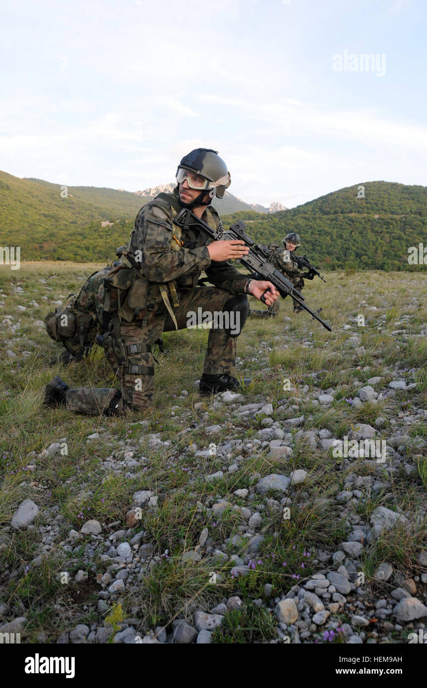 A special operations soldier from Poland checks his rear security after ...
