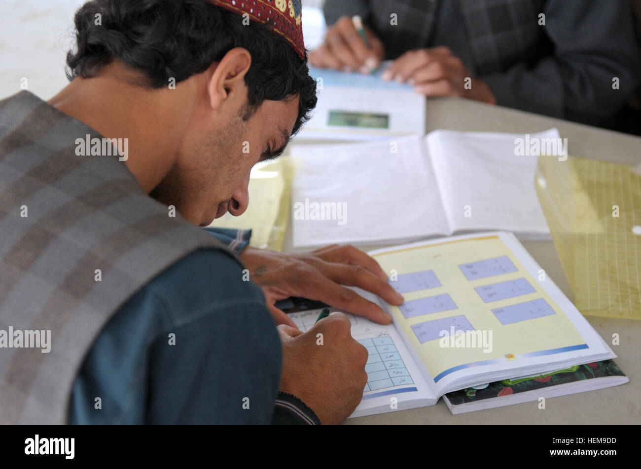 An Afghan Local Police candidate completes class work during a reading ...