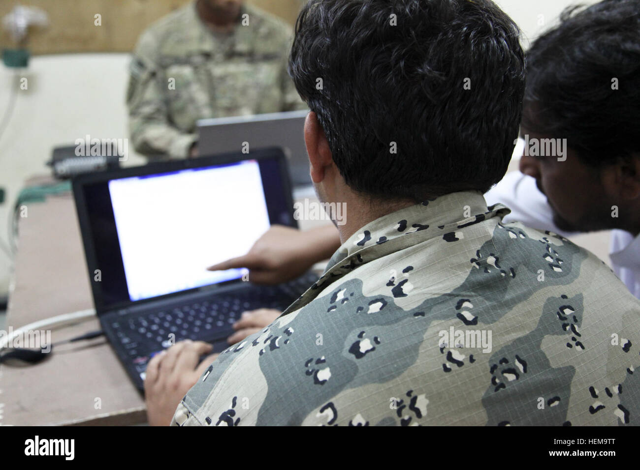 An Afghan Border Police officer, left, practices using spreadsheet ...