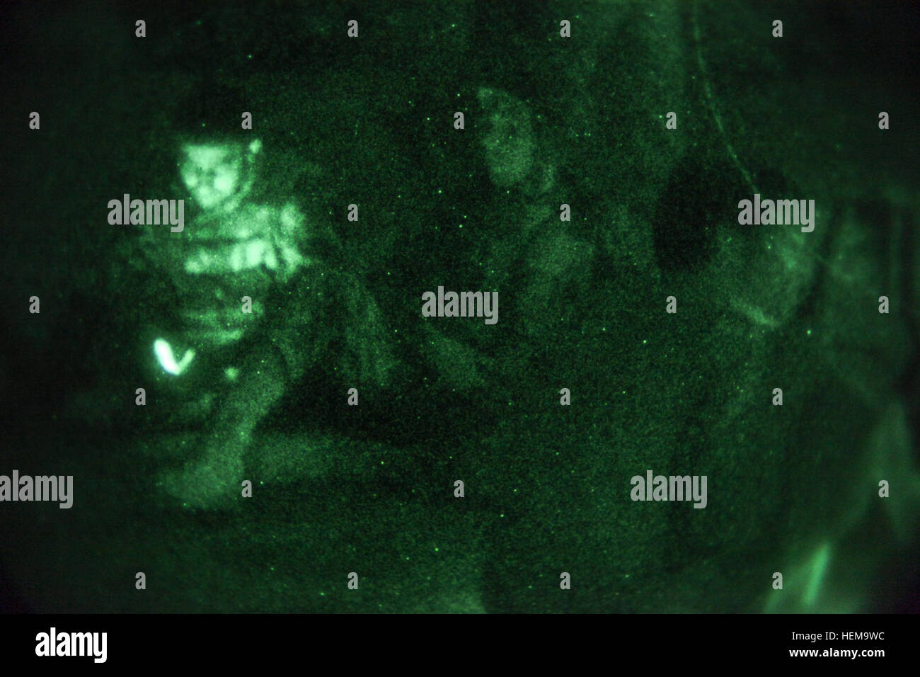 An Afghan soldier checks his phone after staging his gear during ...