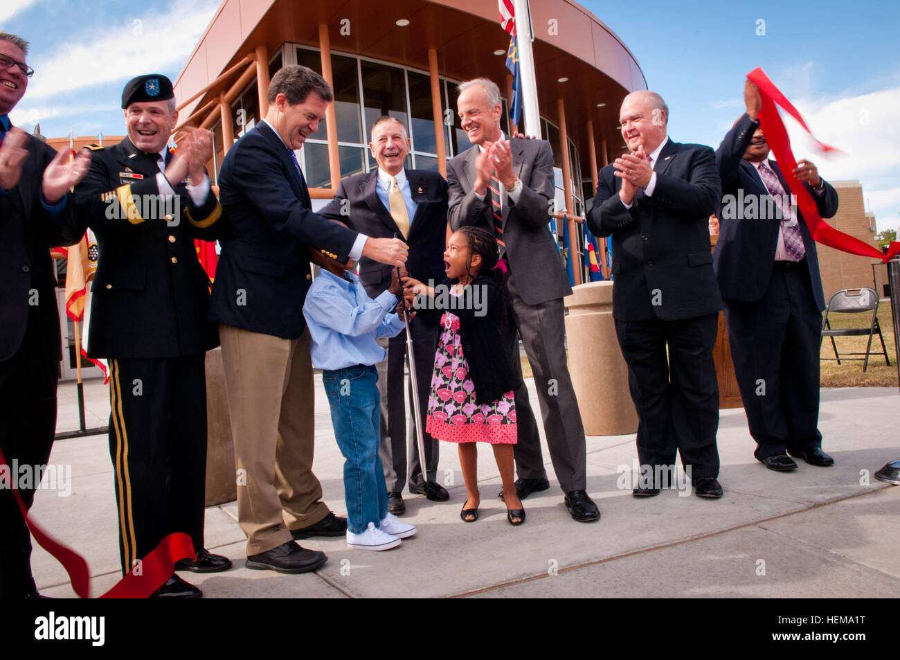 Senior military and civilian leaders gather to cut the ribbon at the ...