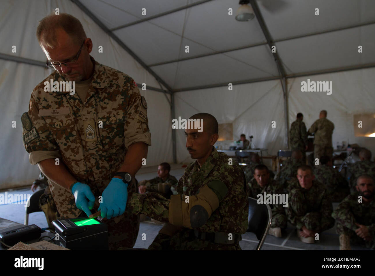 Danish Army Warrant Officer BT, takes the finger prints of an Afghan ...