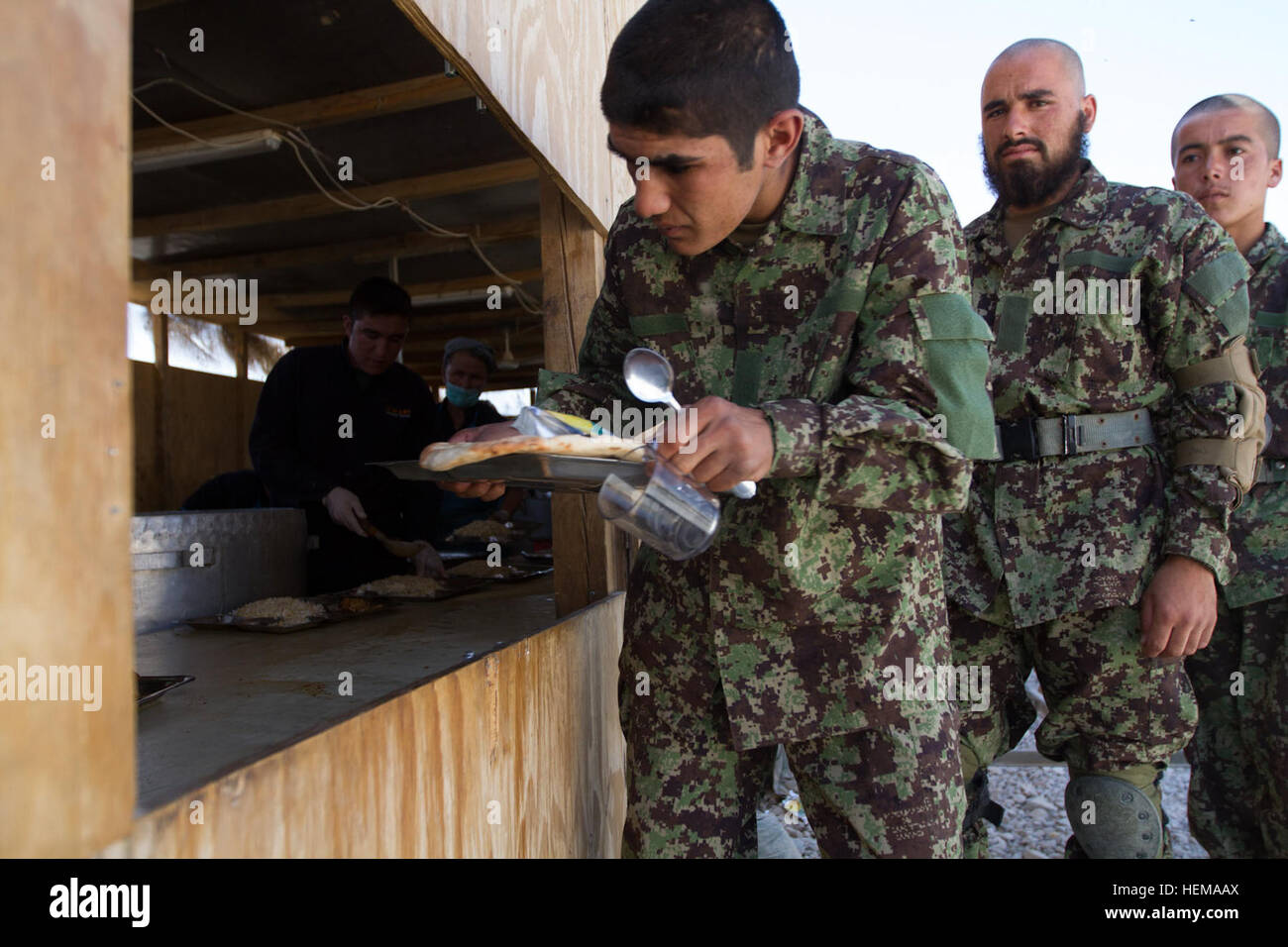 An Afghan National Army soldier takes a tray of food for lunch at the ...