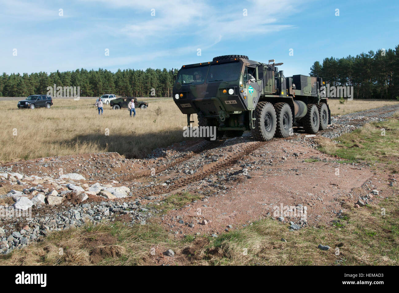 Soldiers gradually navigate a Heavy Expanded Mobility Tactical Truck ...