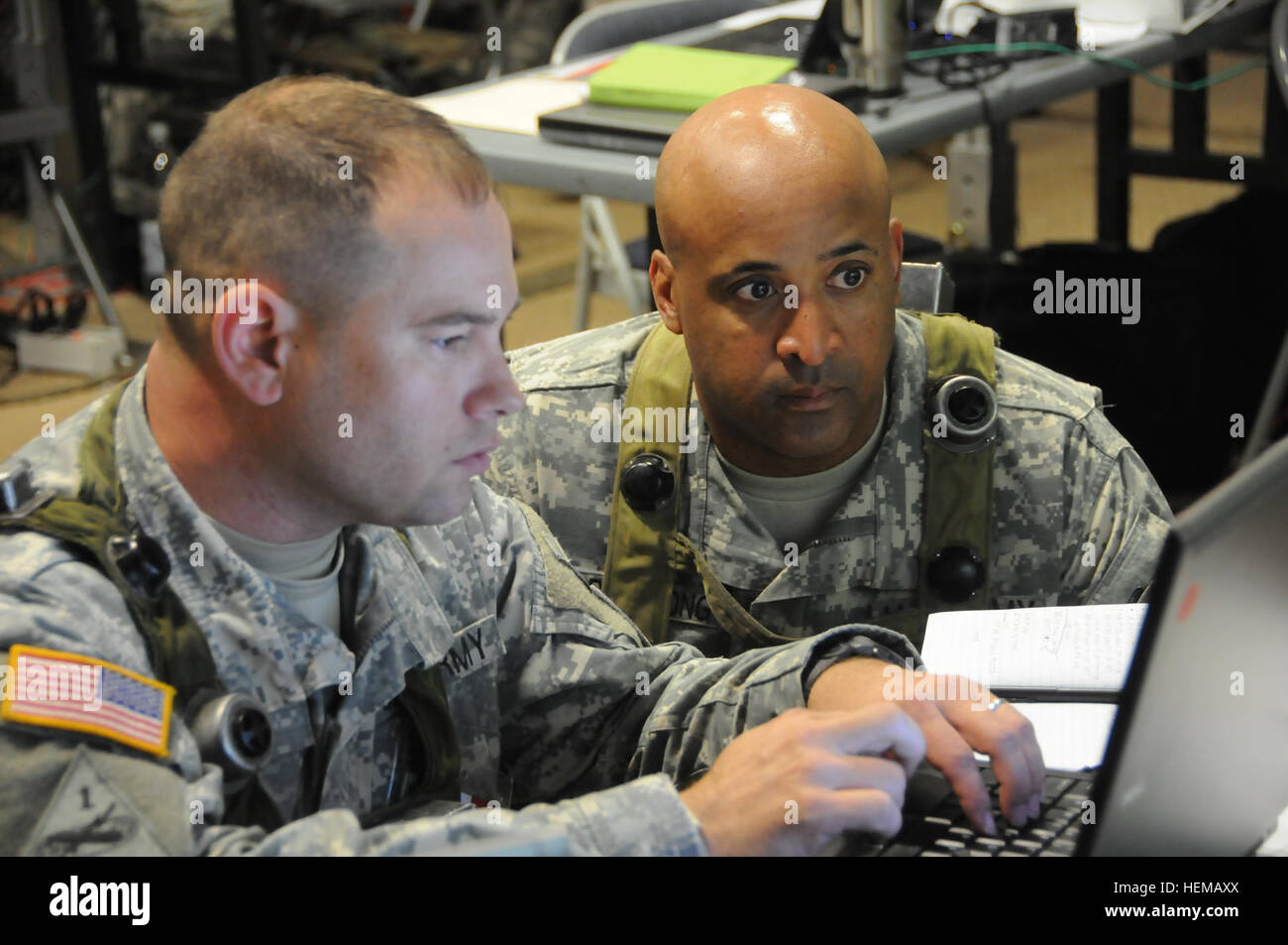 U.S. Army Soldiers of the 2nd Cavalry Regiment work at a computer ...