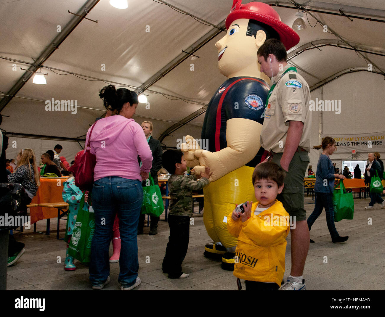 Children and parents gather around 'the inflatable fireman,' a sort of ...