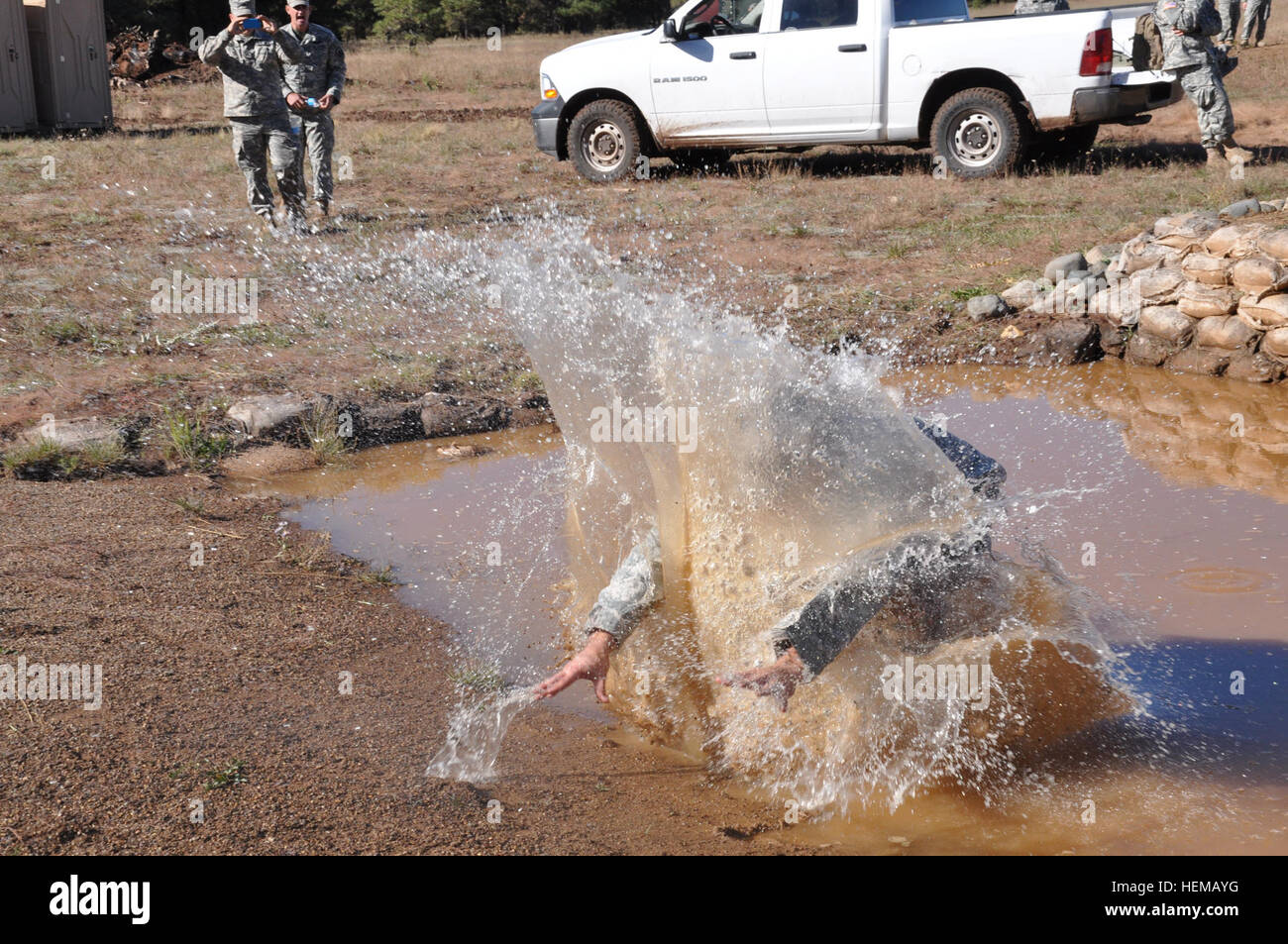 A soldier jumps into the murky water during the surprise event obstacle ...