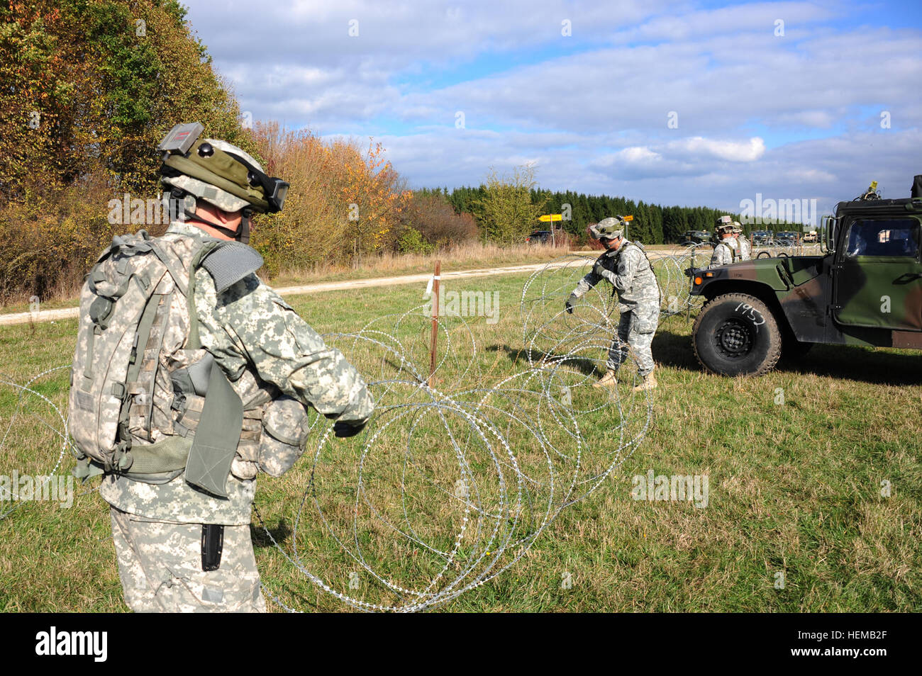 U.S. Army soldiers, from 2nd Cavalry Regiment, rolls up Constantia wire ...