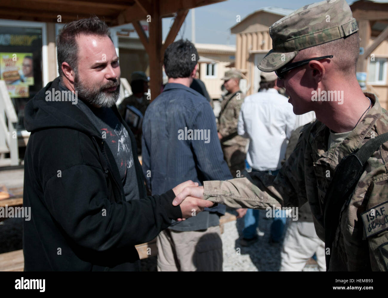 Comedian Shawn Halpin shakes hands with soldiers, after a performance ...