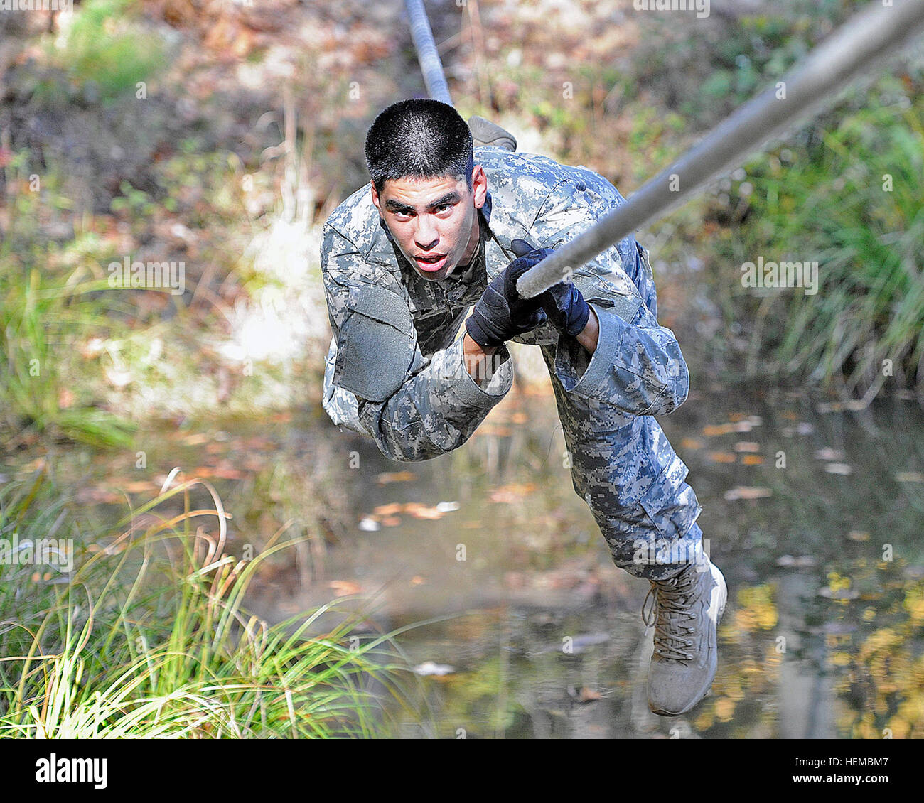 U.S. Army Spc. Luis Lopez crosses a water obstacle while competing in ...