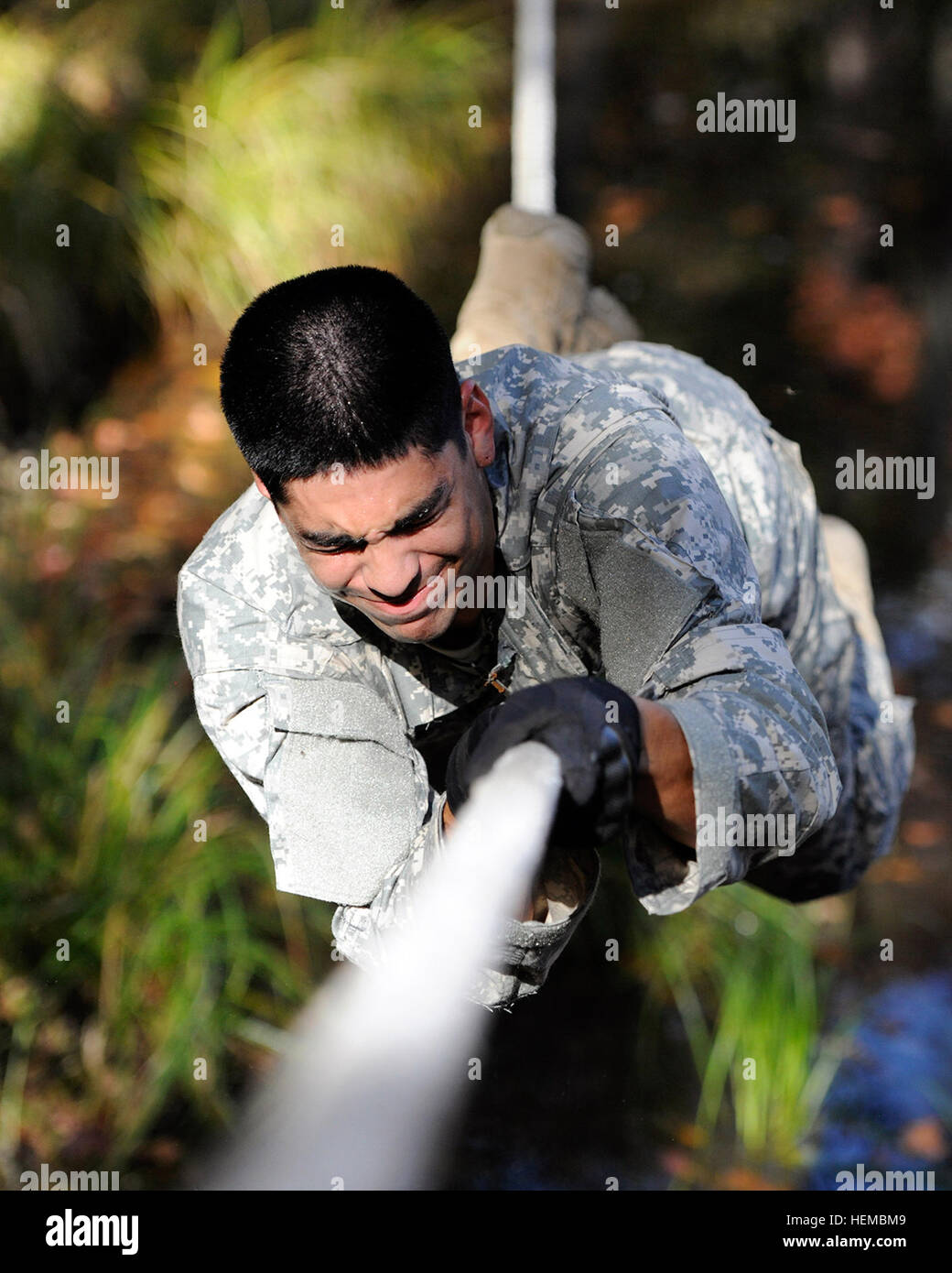 U.S. Army Spc. Luis Lopez crosses a water obstacle while competing in ...