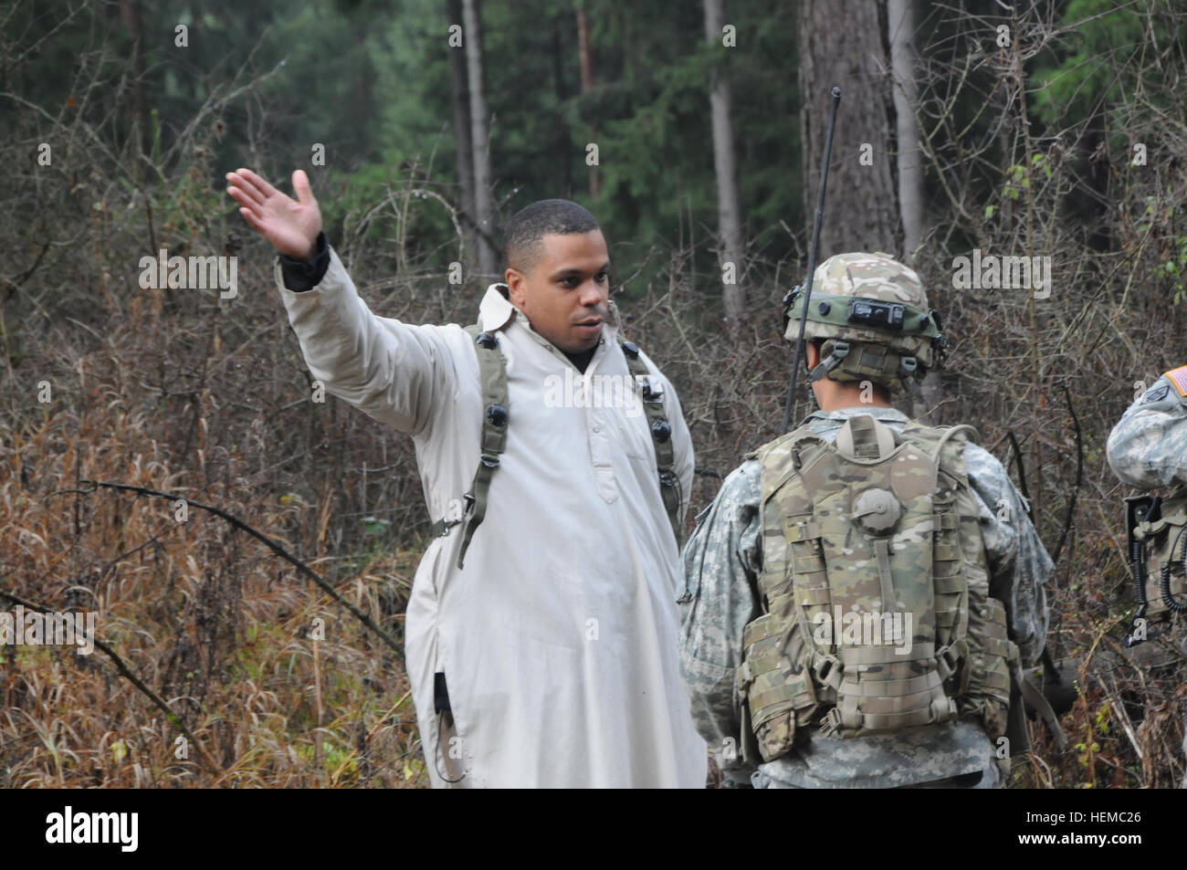 A U.S. Army soldier from the 370th Engineer Company questions a soldier ...