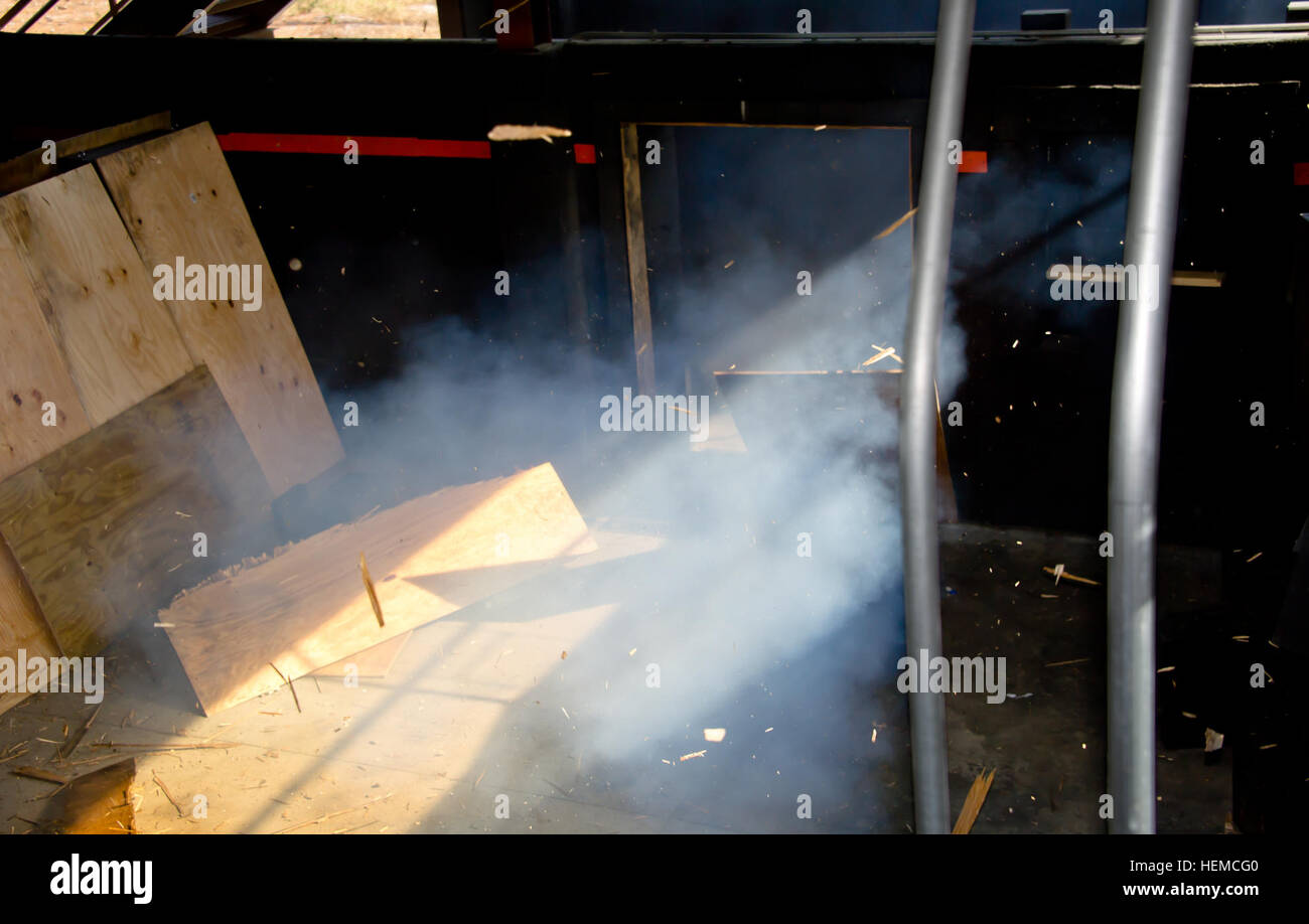 The sun beams down through smoke and debris as wooden doors explode ...