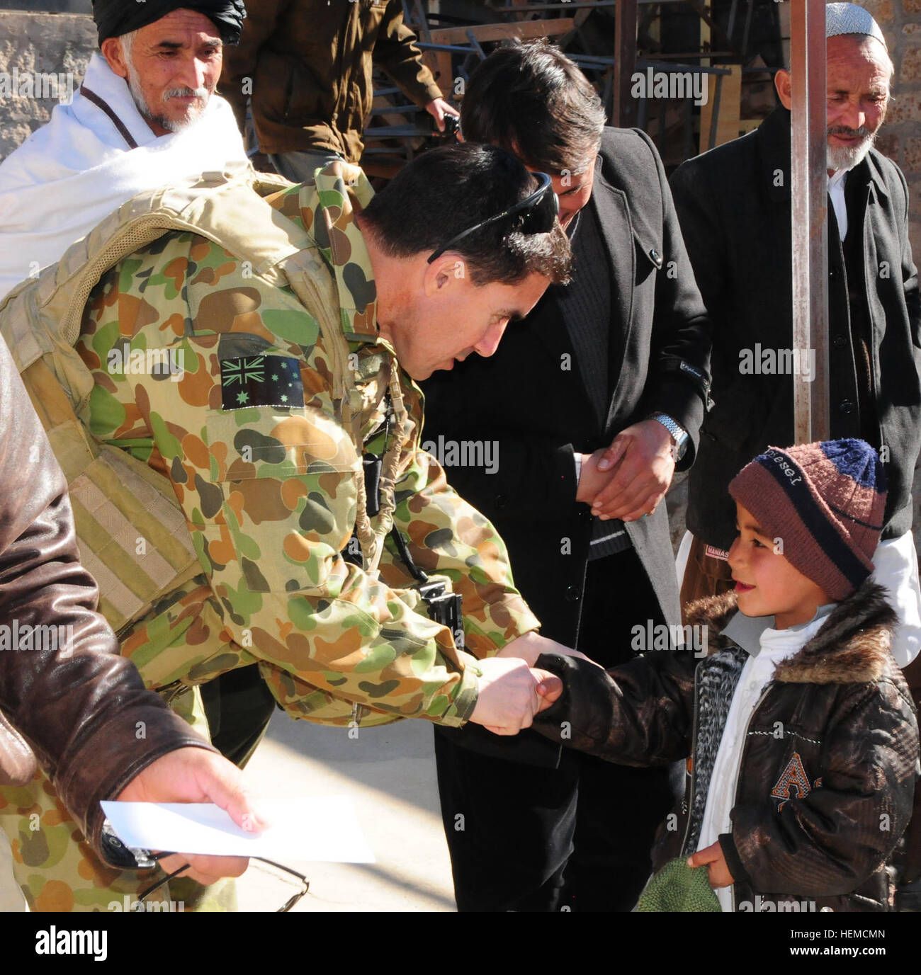 Australian Army Col. Simon Stuart, Combined Team Uruzgan commander, shakes the hand of an Afghan ...