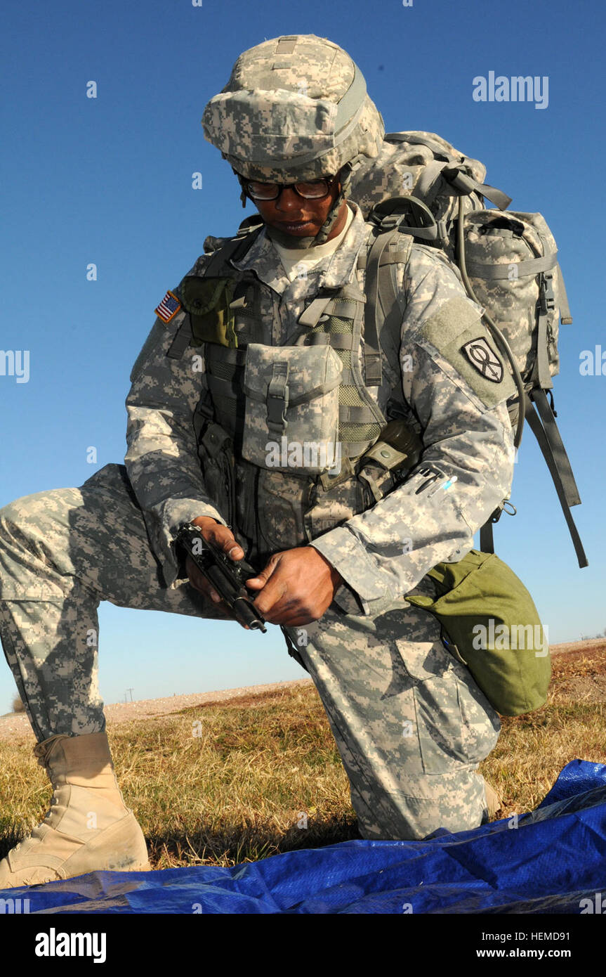 U.S. Army Pfc. Quinton Cox disassembles an M9 Beretta pistol during the ...
