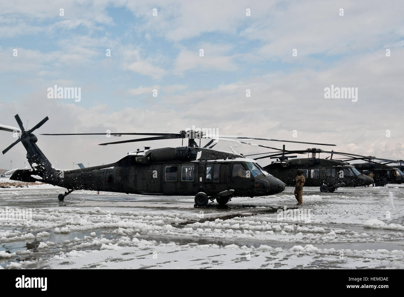 Snow flies off the rotor blades of a UH-60 Black Hawk helicopter as its ...