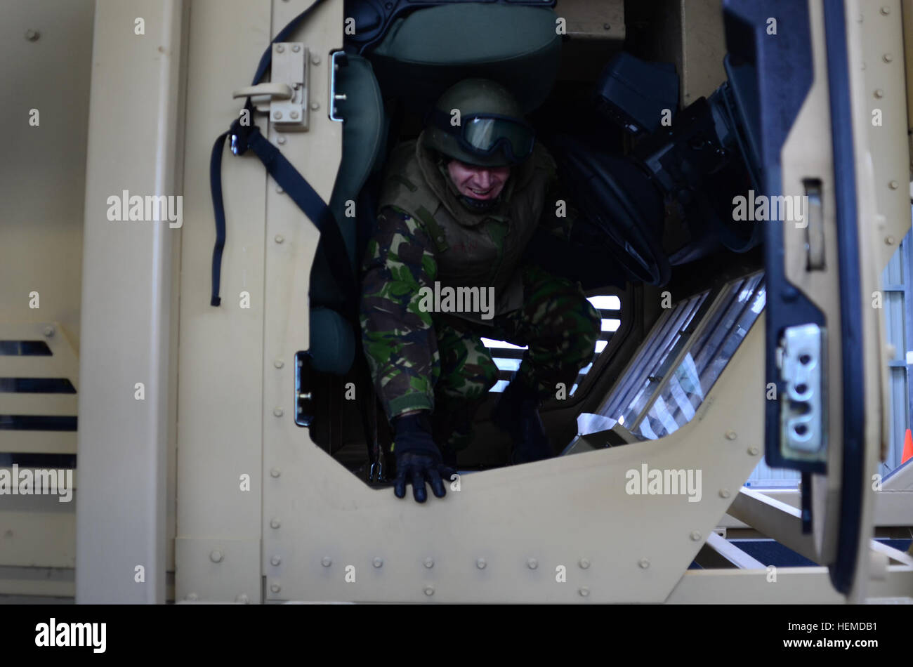 Romanian army soldiers exit a Humvee egress assistance trainer during a ...