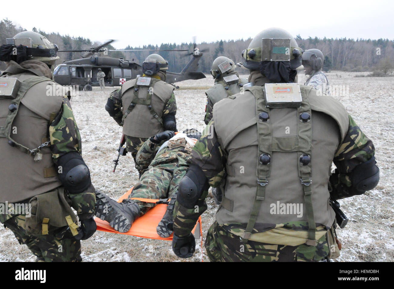 Romanian soldiers carry a simulated casualty to a UH-60 Black Hawk for ...