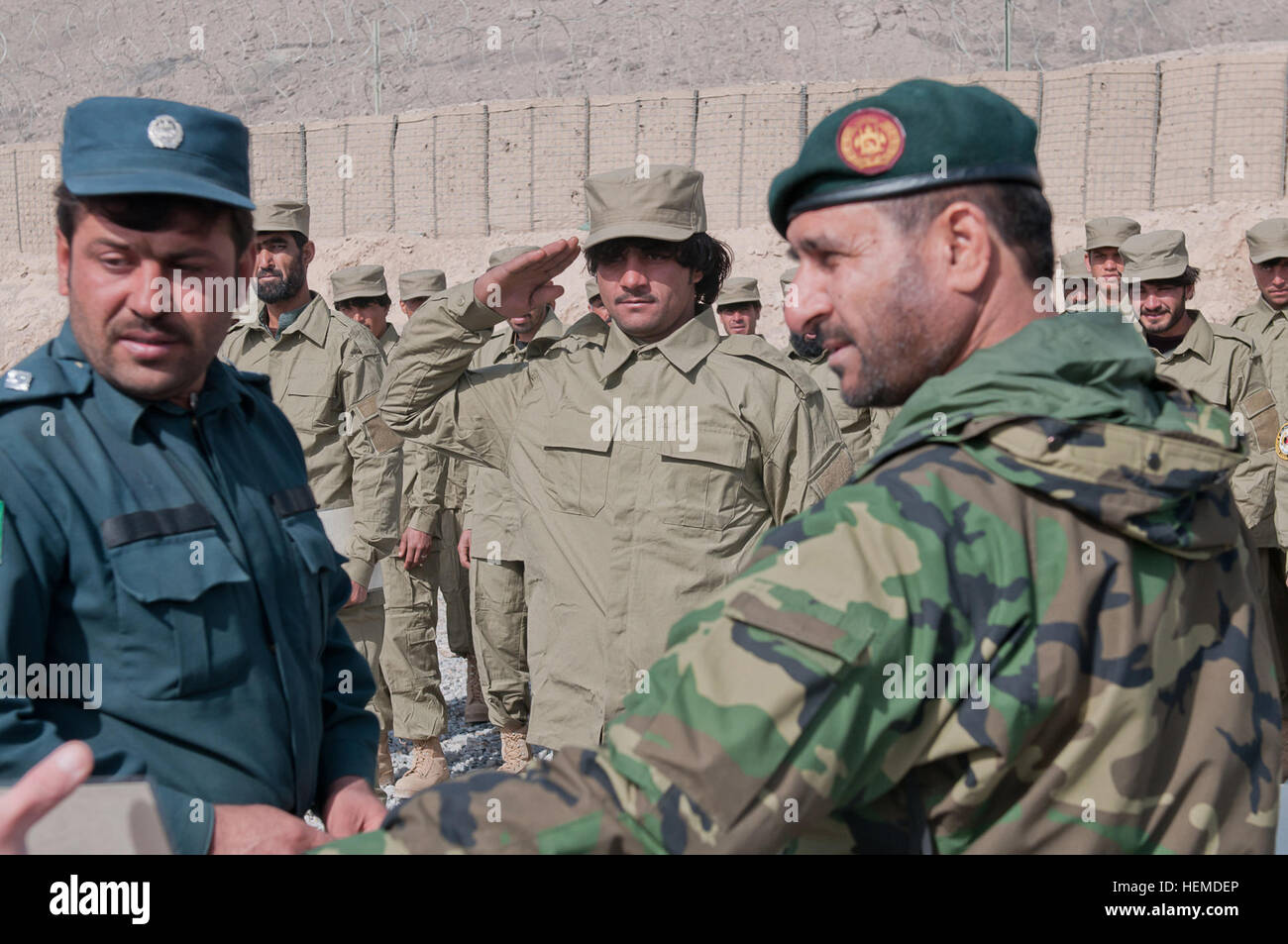 A new Afghan Local Police (ALP) member salutes an Afghan National Army ...