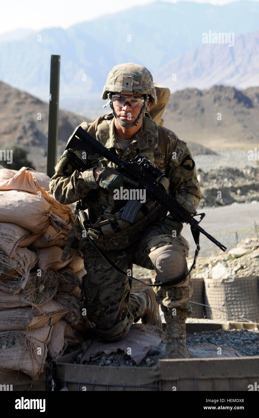 U.S. Army 2nd Lt. Jose Collazo pulls security armed with an M4 carbine ...