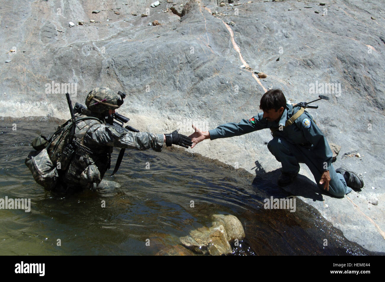 An Afghanistan national police officer helps Army 2nd Lt. Jonathon ...