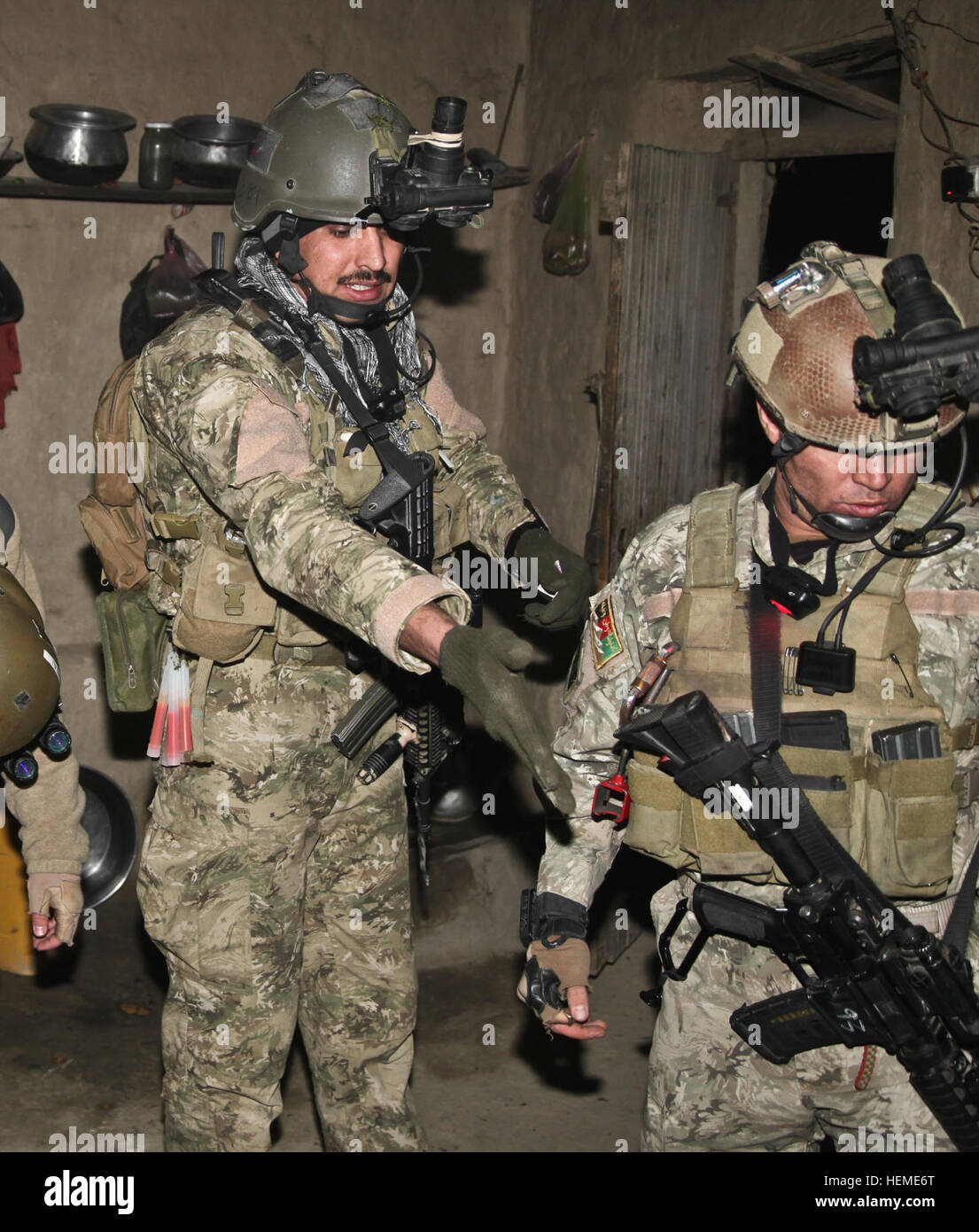 Afghan coalition security force members search a home during an ...