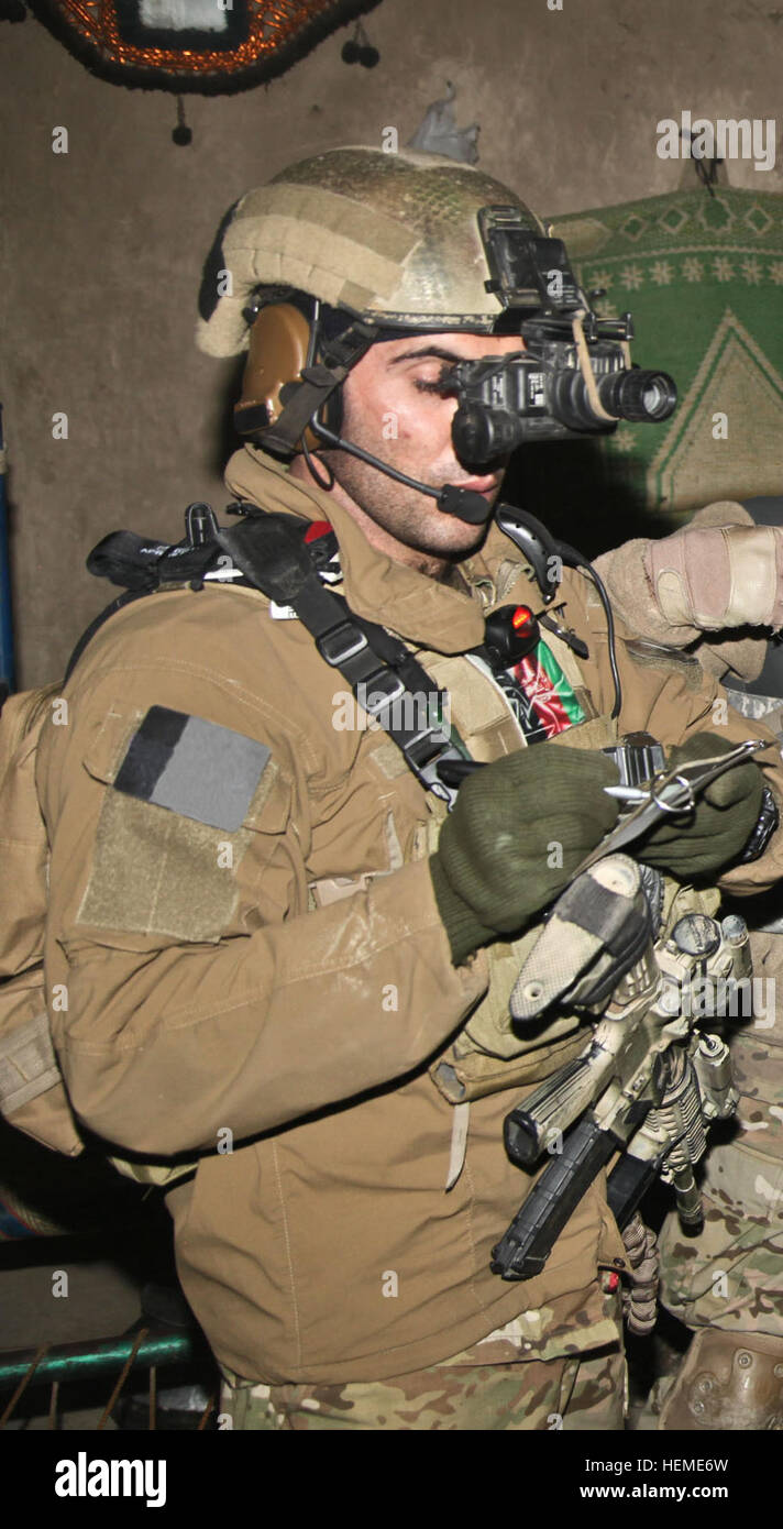 An Afghan coalition security force member searches a home during an ...