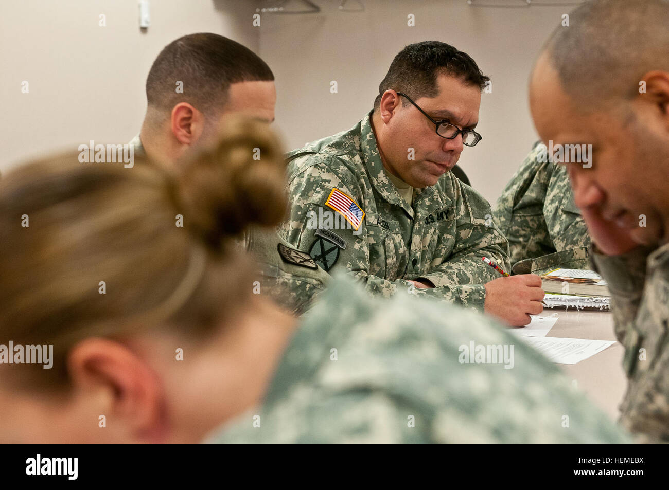 U.S. Army Spc. Leonard Allen, center, a shower/laundry and clothing ...