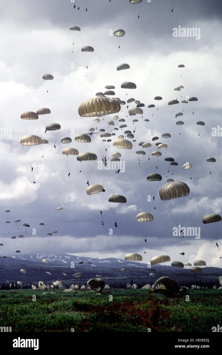 Floating on mushrooming green parachutes, members of the 1st Battalion ...