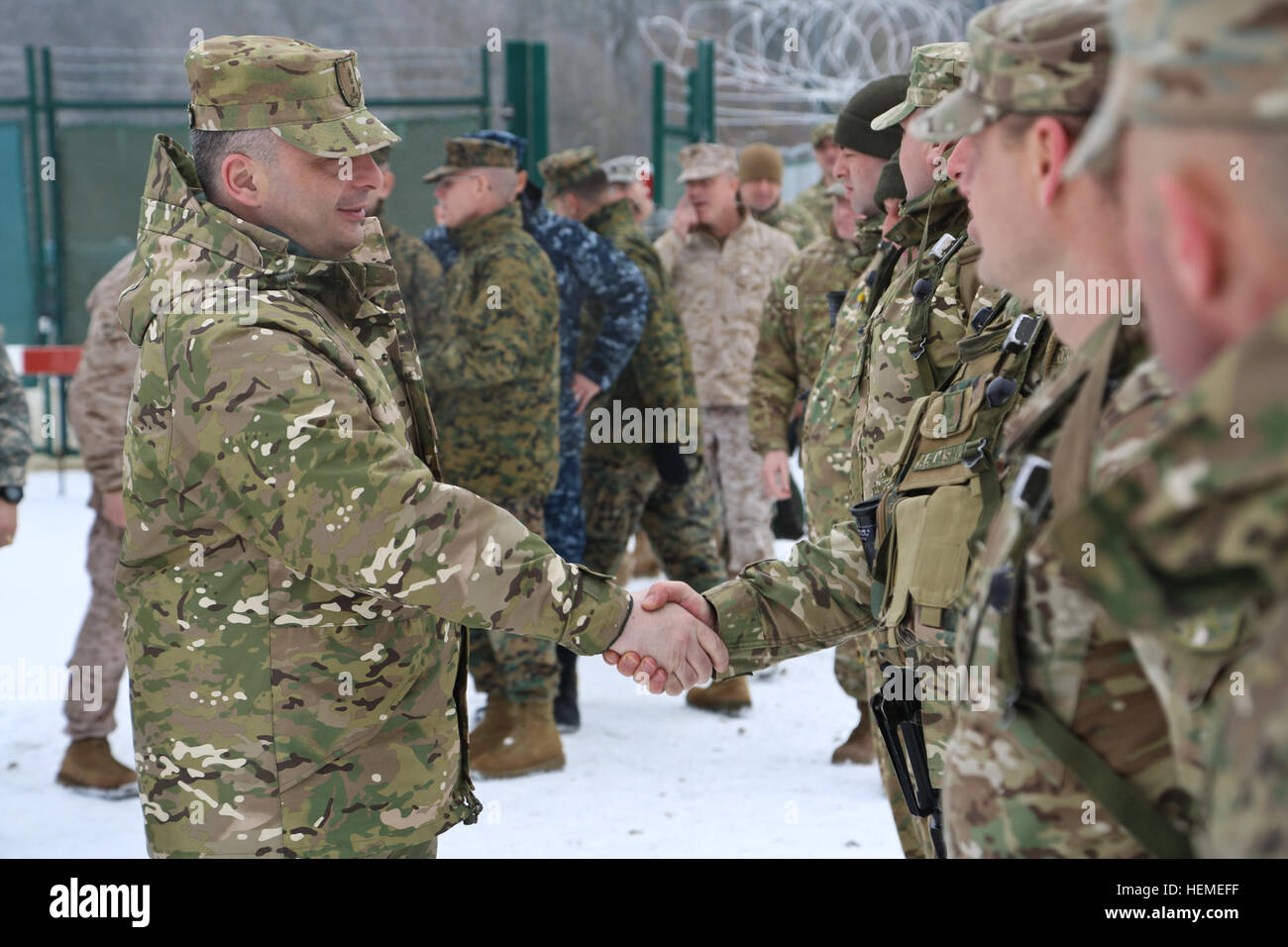 A Georgian army colonel shakes hands with a Georgian army soldier ...