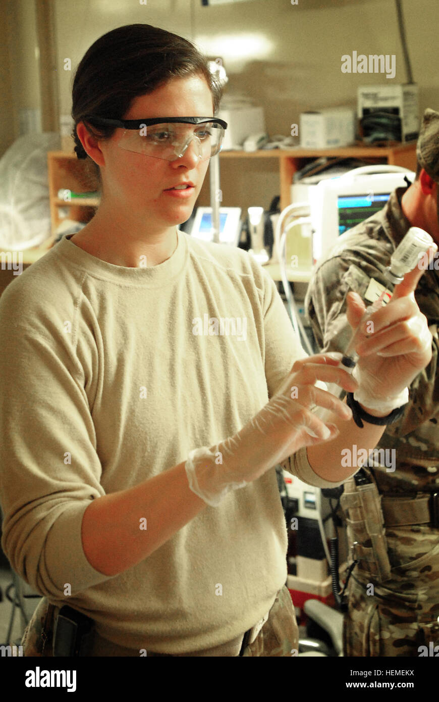U.S. Air Force Senior Airman Jocelyn Frenyea prepares a syringe in the ...
