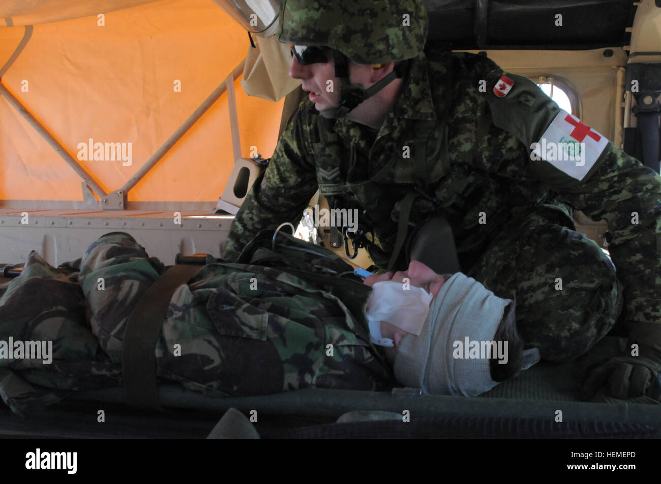 Canadian Forces (CF) Cpl. Jason Foote, center, a medic assigned to the ...