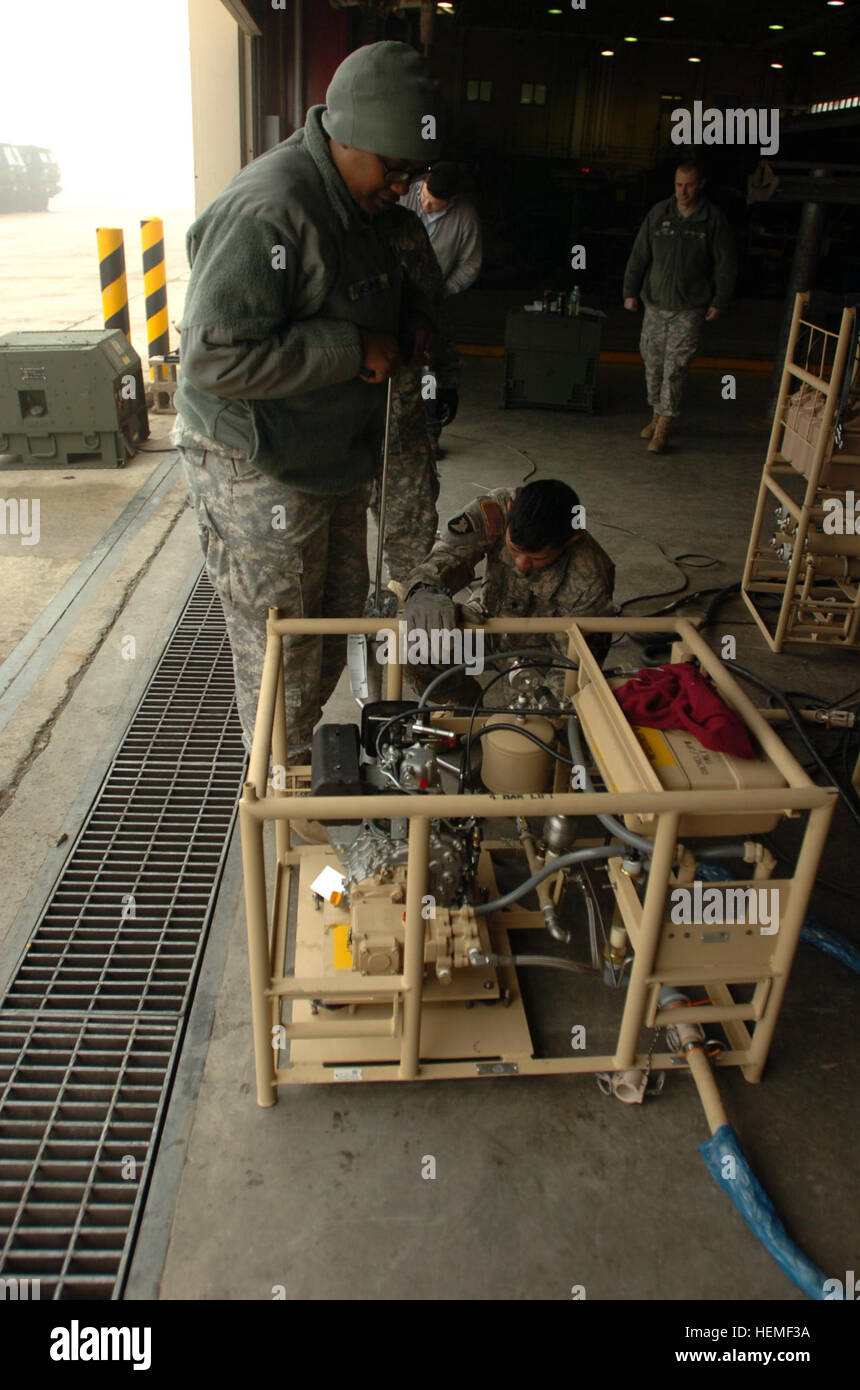 U.S. Army Spc. Brittany Jenkins, left, pumps air into a lightweight ...