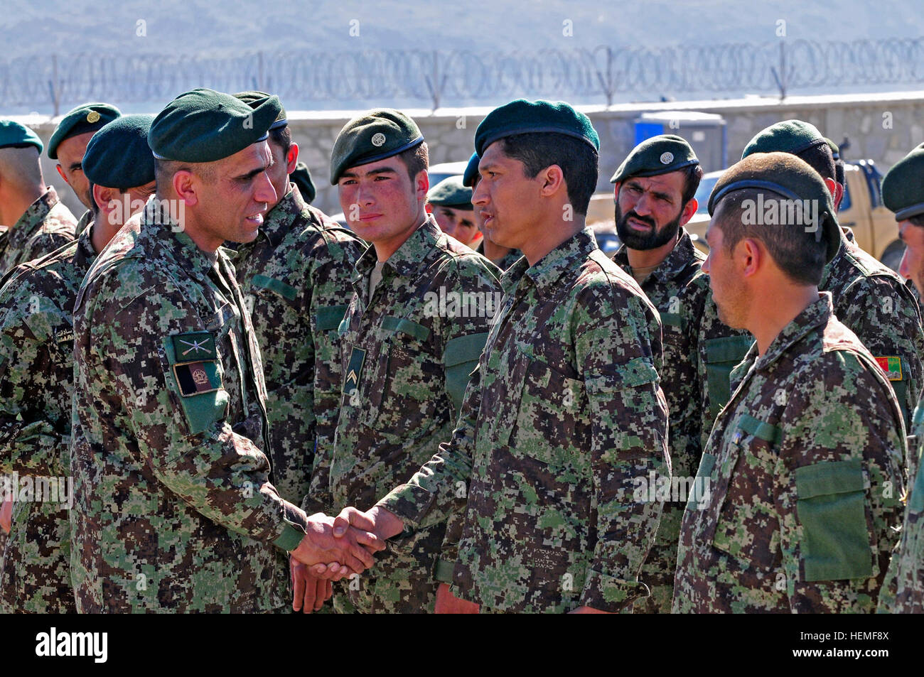 Afghan Sgt. Maj. of the Army Roshan Safi, left, greets a soldier ...